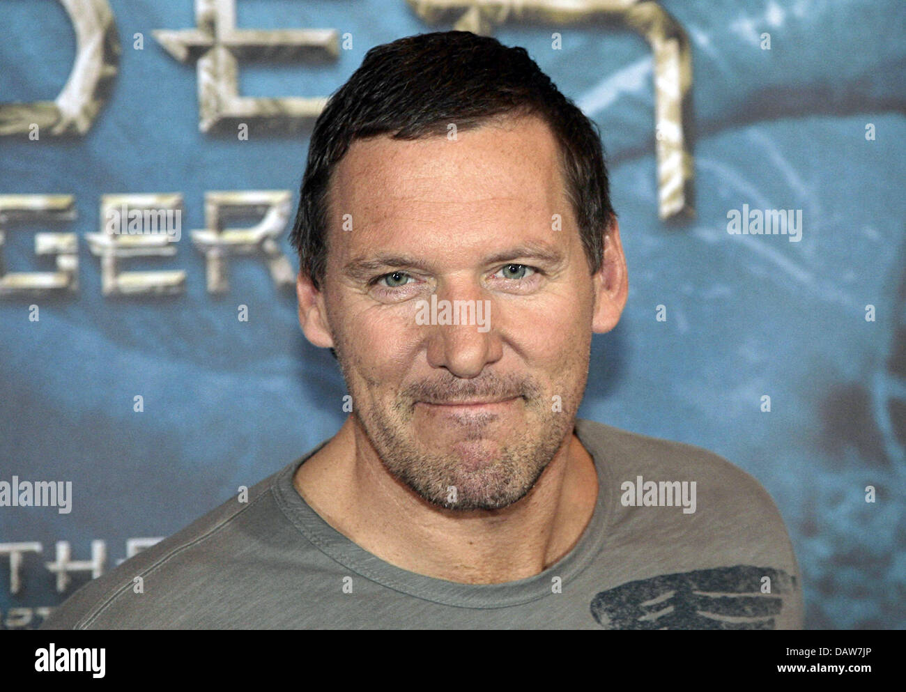 German actor Ralf Moeller poses in front of a film poster for his new ...