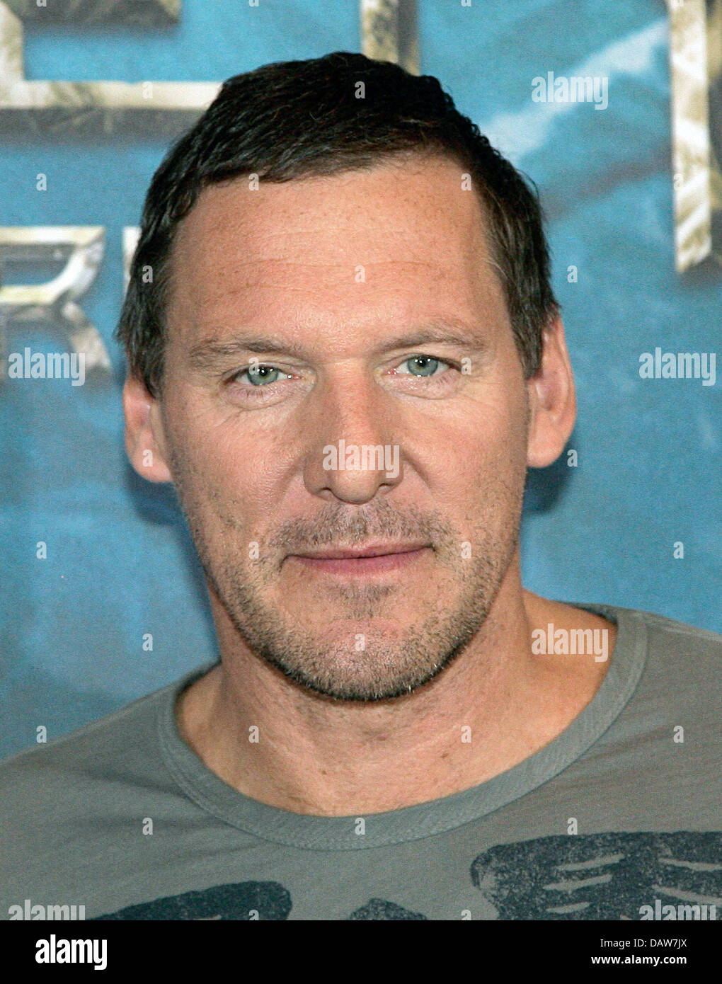 German actor Ralf Moeller poses in front of a film poster for his new ...