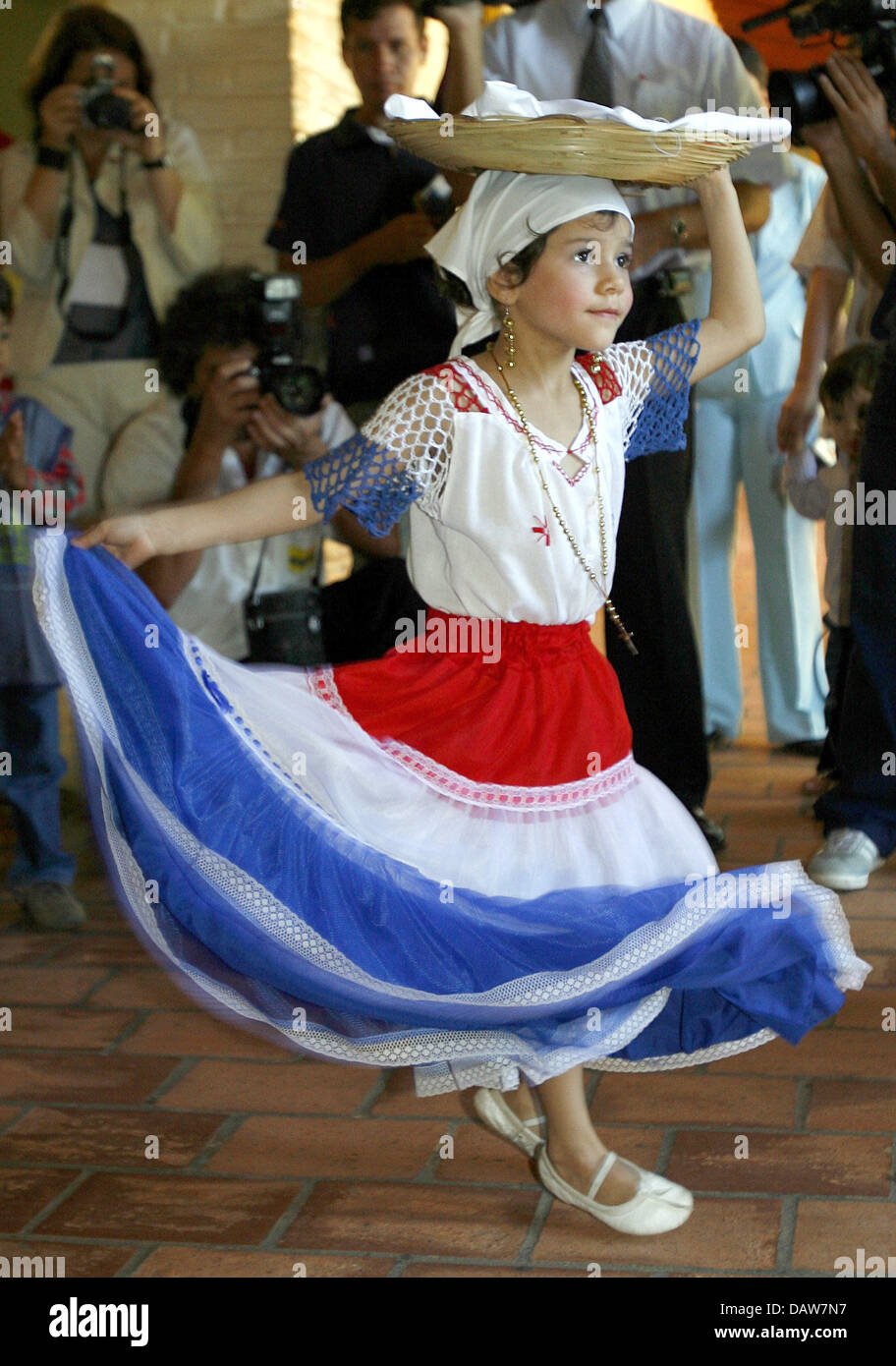 A girl in traditional clothes dances at the day nursery 'Cynthia ...