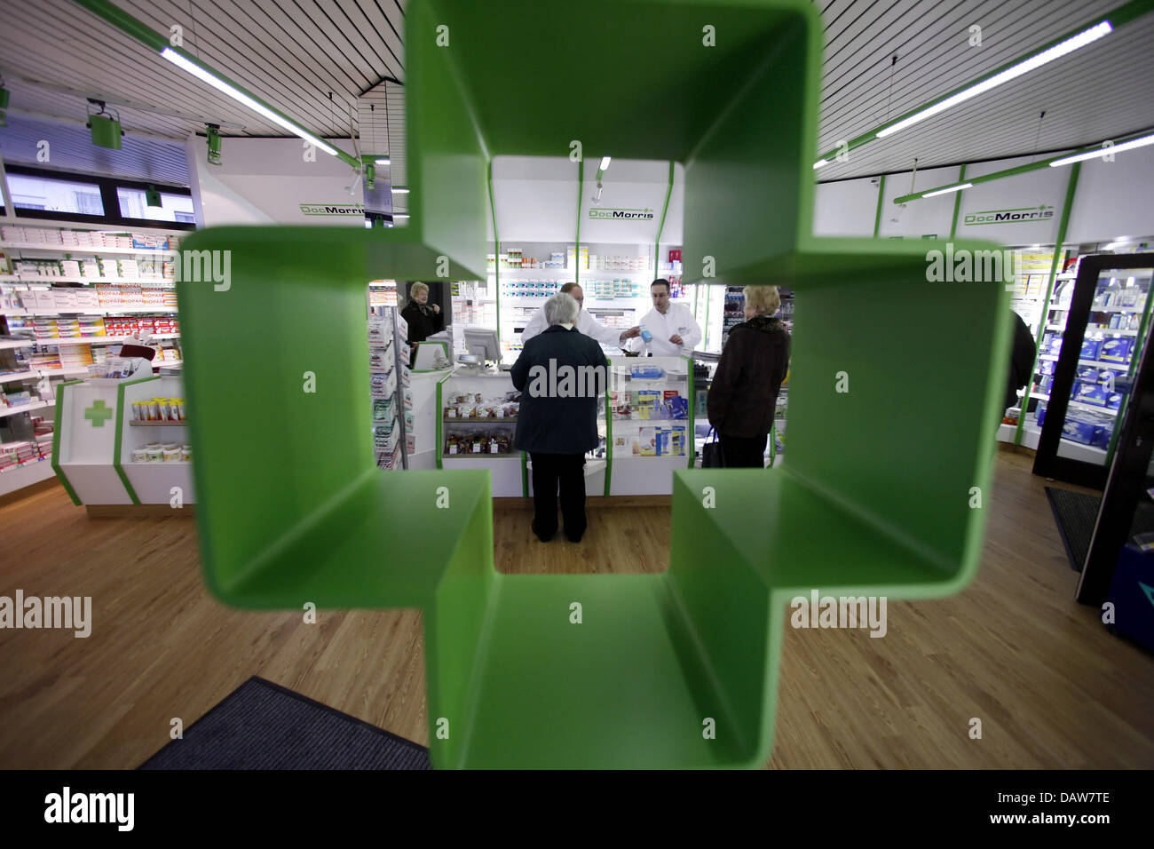 Customers shown behind the company logo at the first DocMorris pharmacy ...