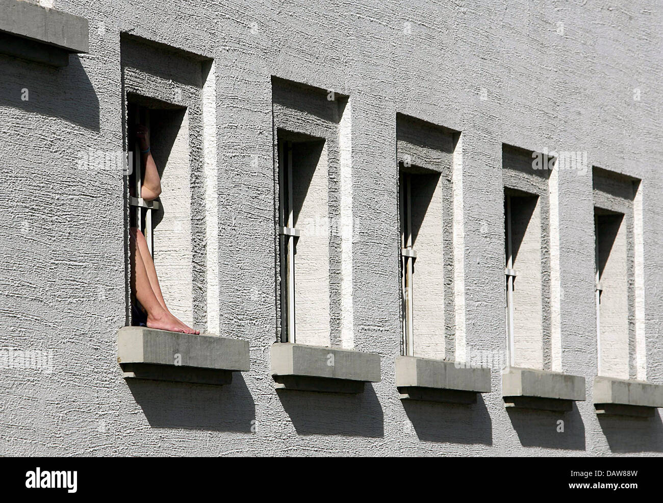 A prisoner suns her legs in the female wing the correctional facility ...