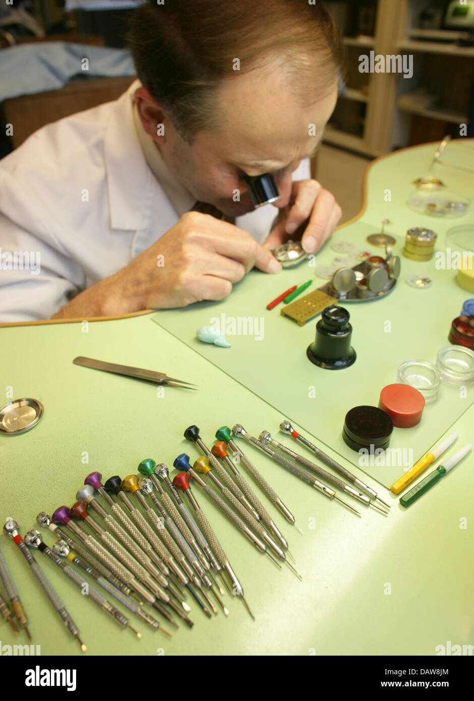 Watchmaker Erich Muecke repairs a Rolex luxury wrist watch at the ...