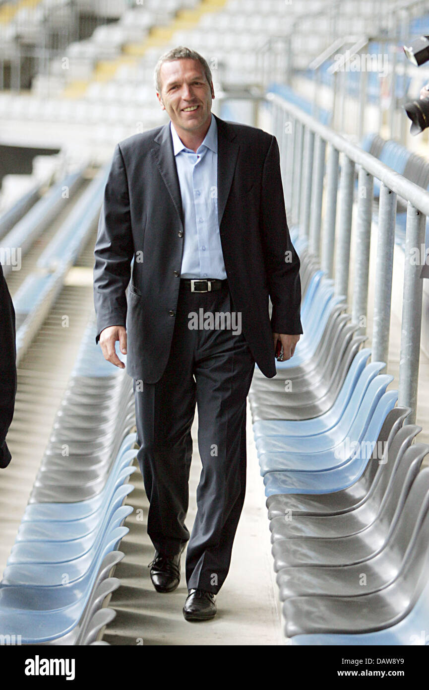 Ernst Middendorp walks and smiles between the grandstand seats at the ...
