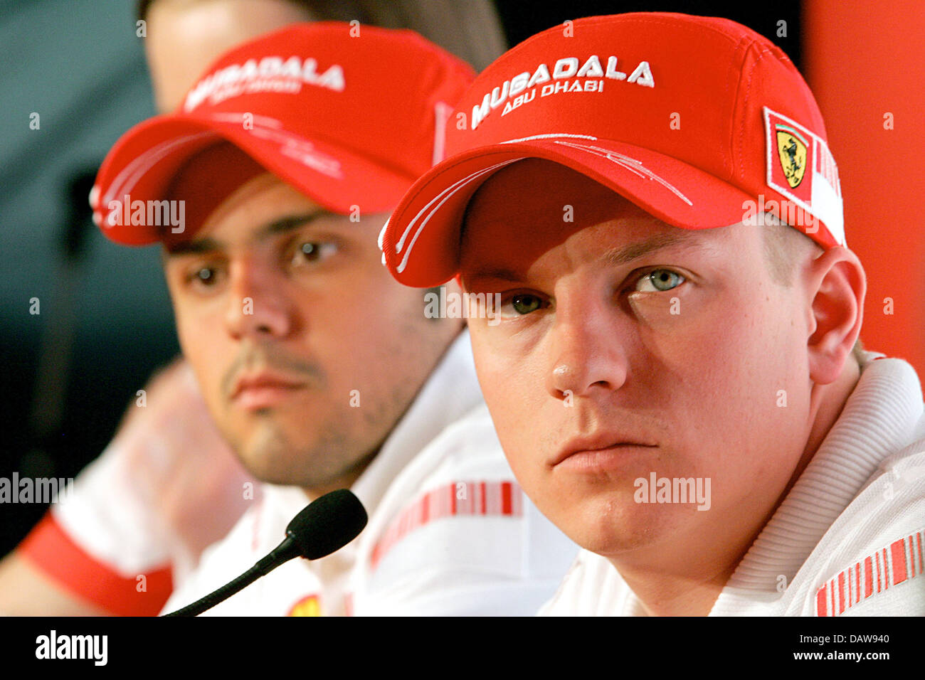 Brazilian Formula 1 pilot Felipe Massa (L) looks to his teammate ...