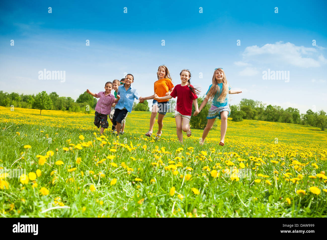 Children running in field flowers hi-res stock photography and images ...