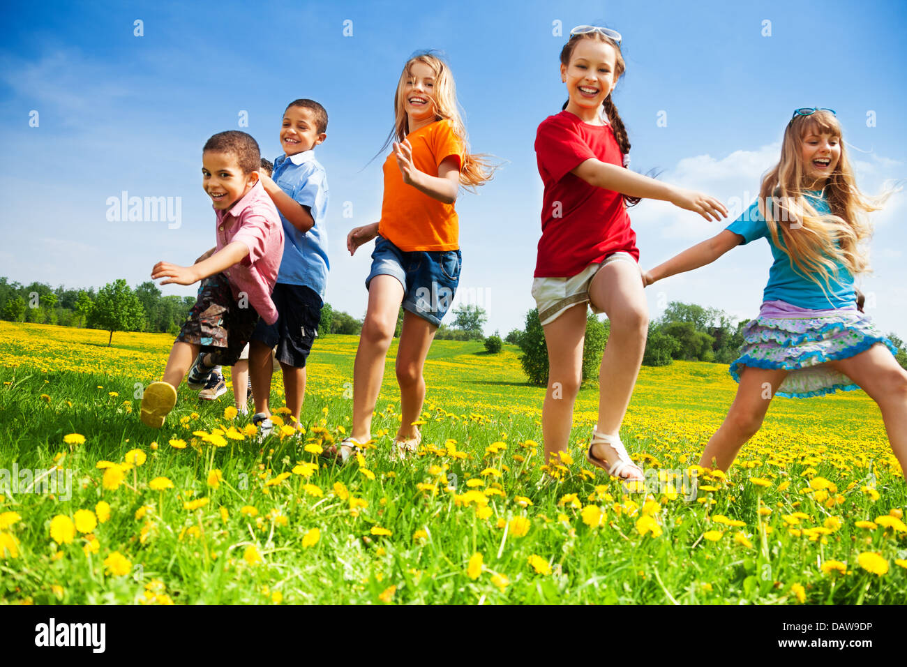 Five happy diversity looking children running in the park Stock Photo ...