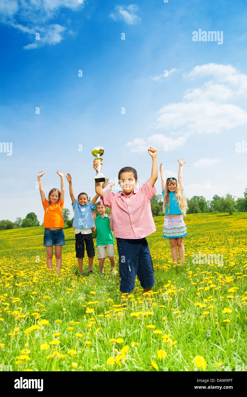 Wining team - group of kids, black and Caucasian, boys and girls on the ...