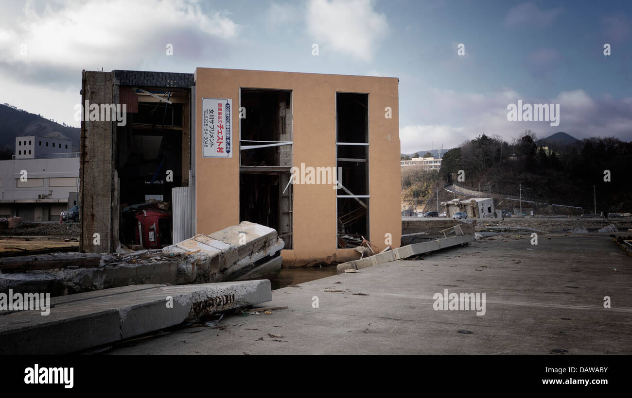 Toppled house at the badly damaged and leveled Onagawa Town in Miyagi ...