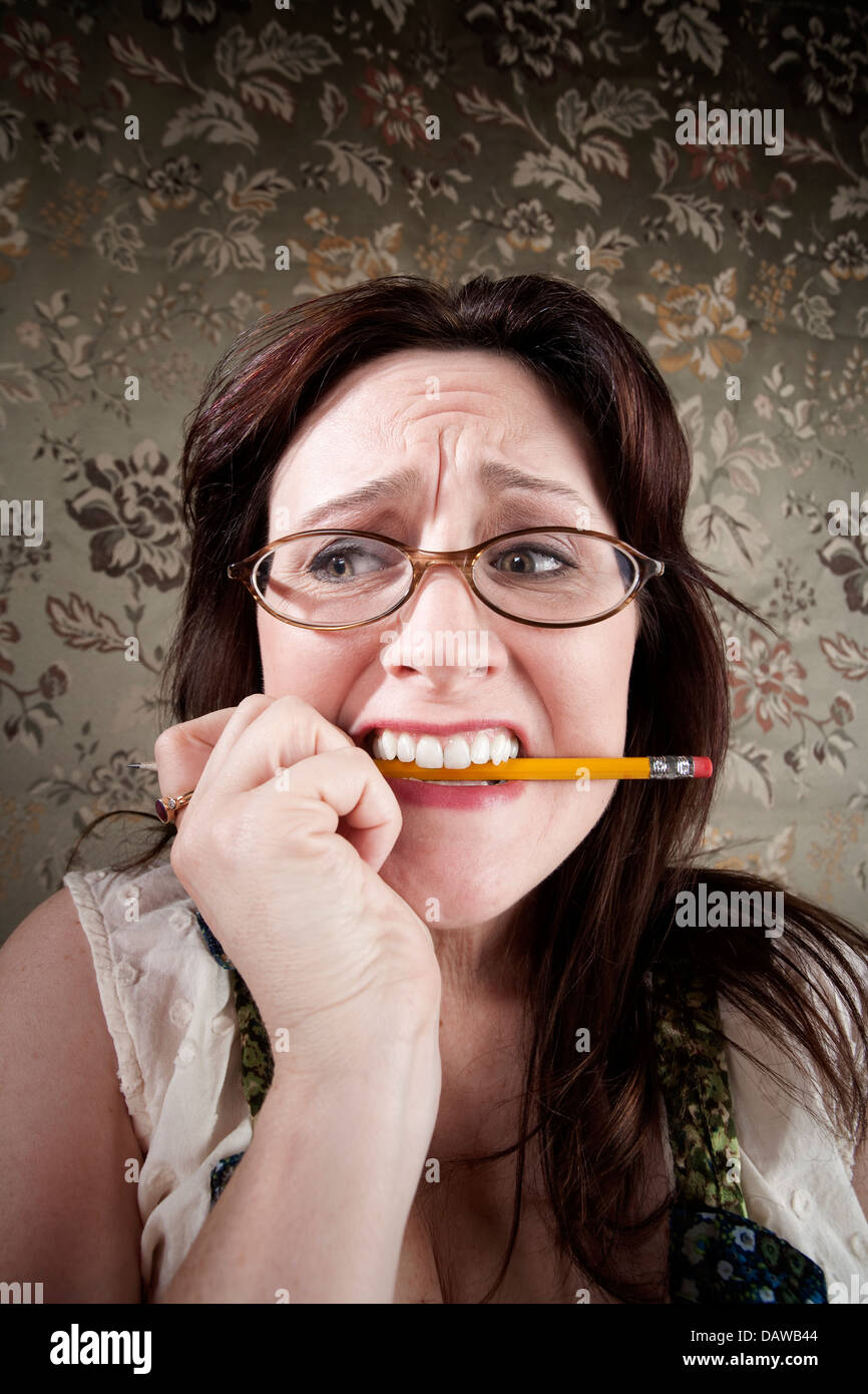 Nervous Woman Chewing on a Pencil Stock Photo - Alamy