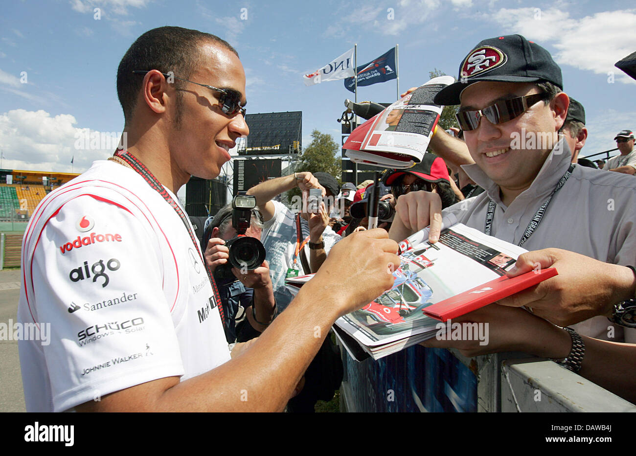 British Formula One rookie Lewis Hamilton (L) of McLaren Mercedes signs ...