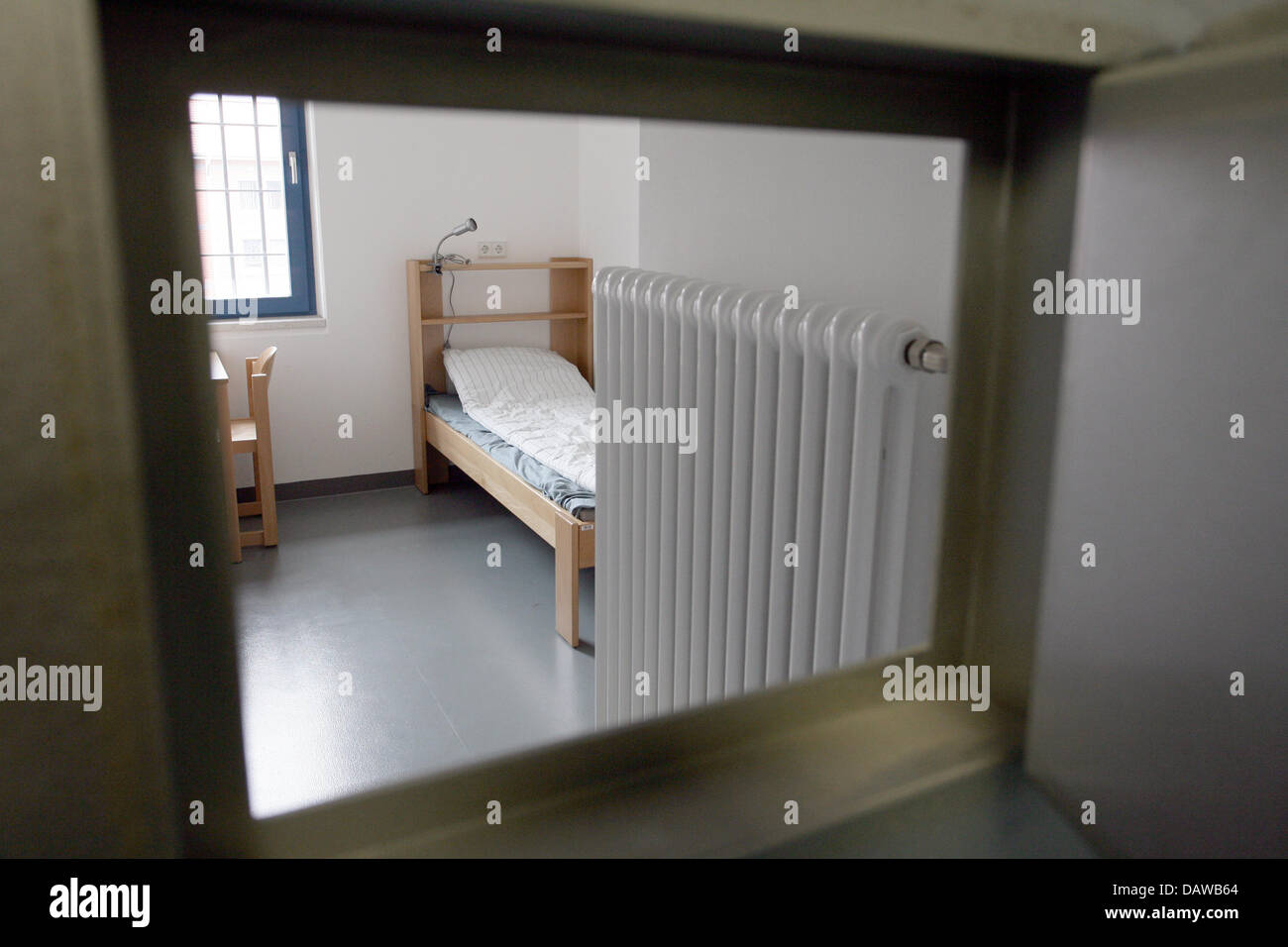 The photo shows the inside of a single prison cell through the door ...