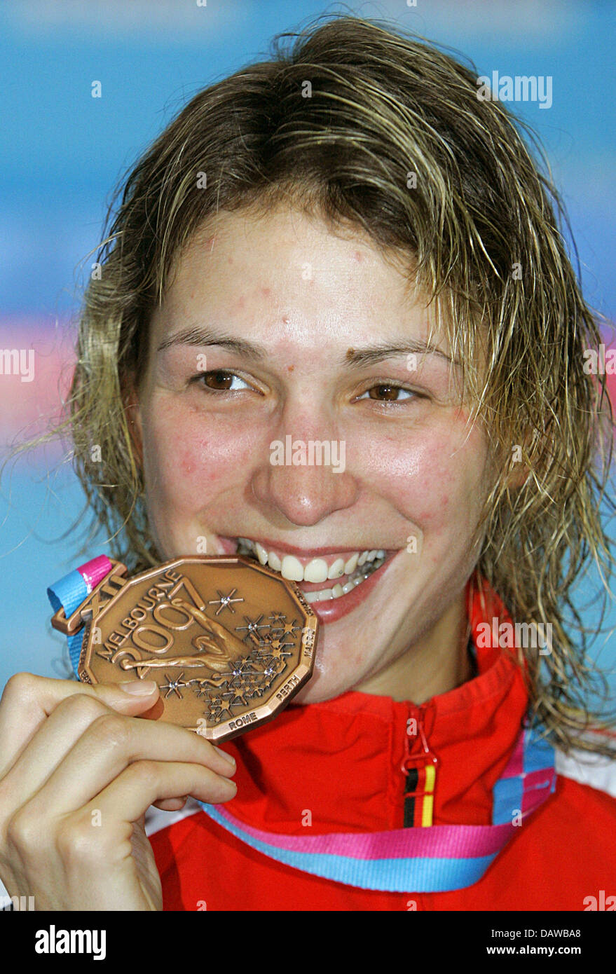 German diver Christin Steuer bites at her bronze medal after the final ...