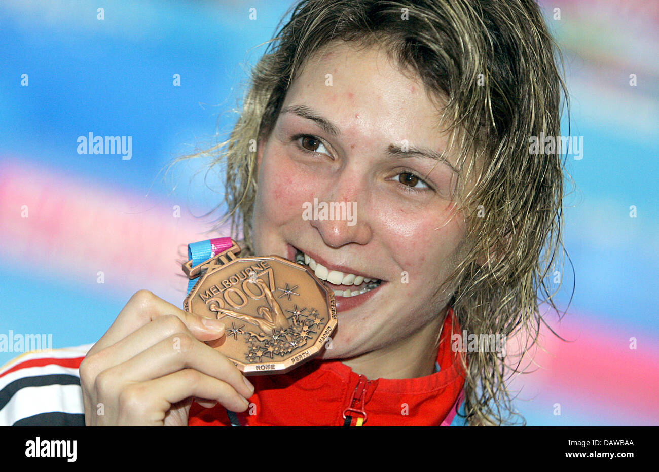 German diver Christin Steuer bites at her bronze medal after the final ...