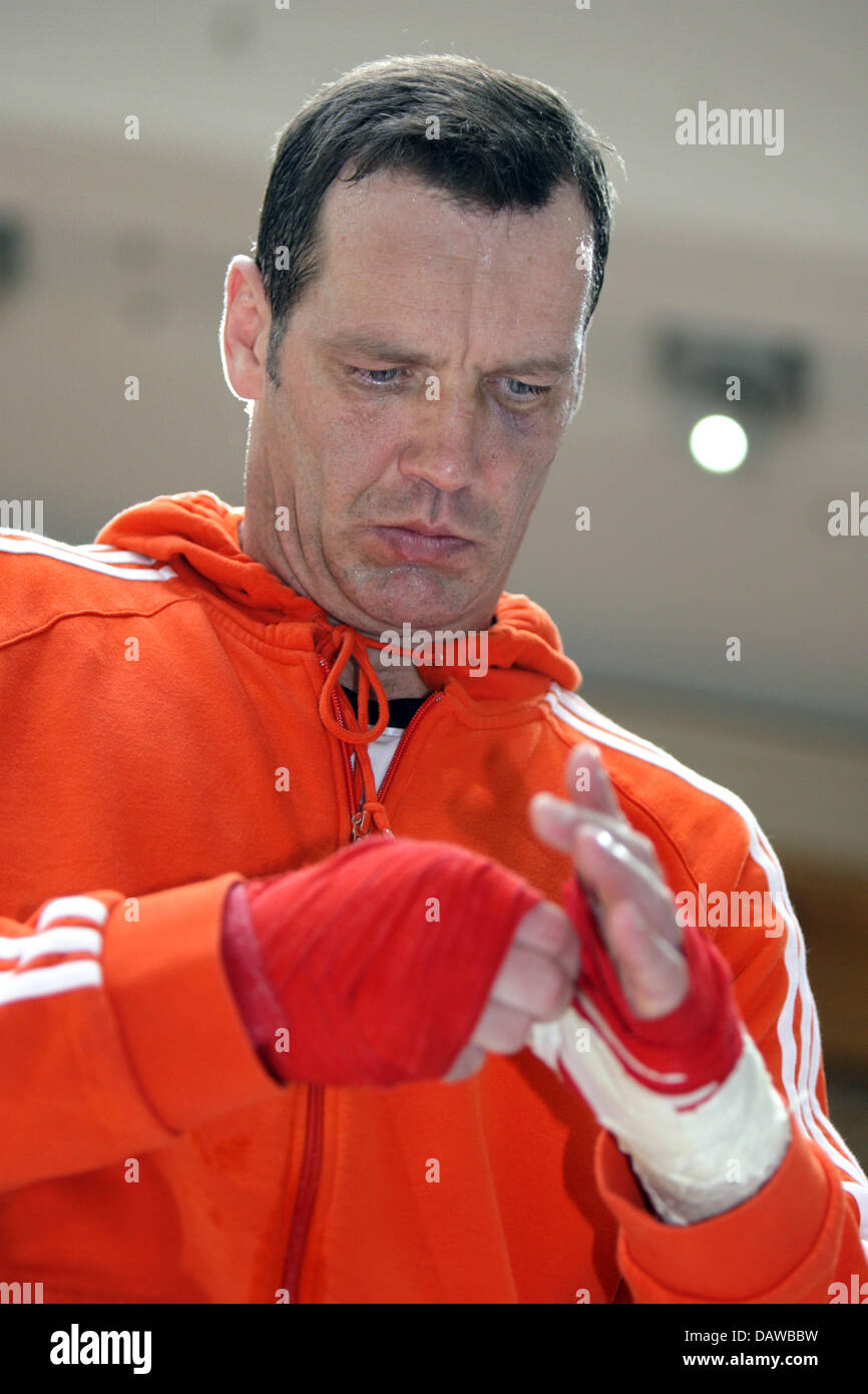 German boxer Henry Maske tapes his fists in the sparring ring at the ...
