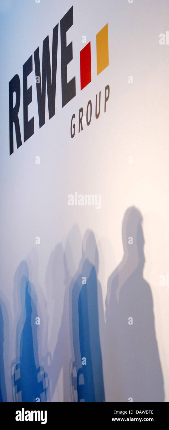 The shadows of the REWE Group management board members are pictured ...