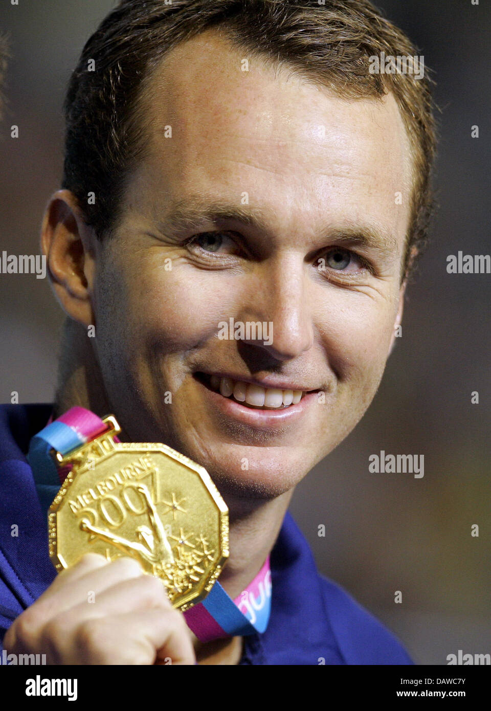 US swimmer Aaron Peirsol poses with his gold medal for the Men's 100m ...