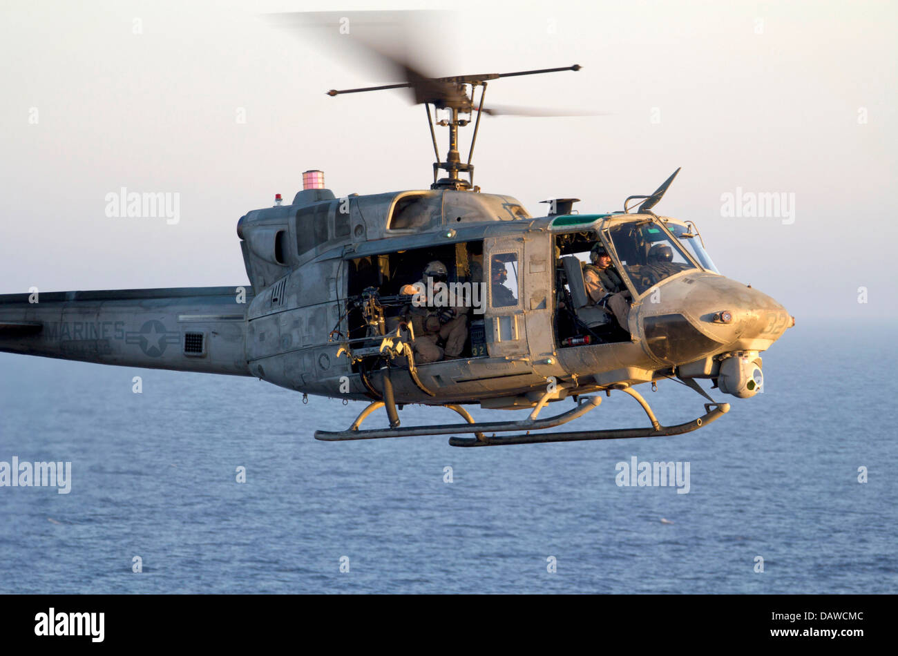 A US Marine Corps UH-1N Iroquois helicopter prepares to land aboard ...