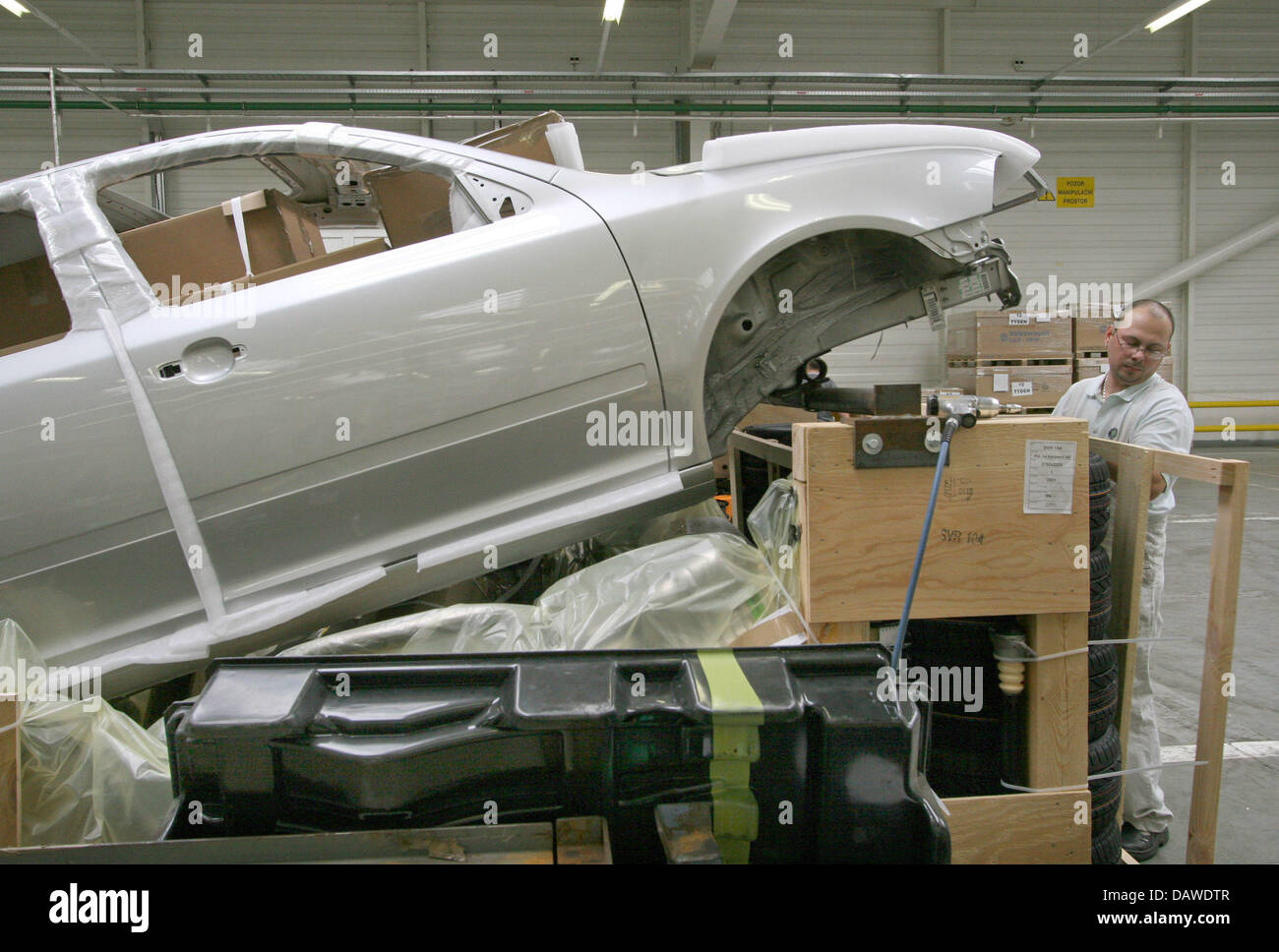 An employee prepares a Skoda Octavia car body for transportation at the ...