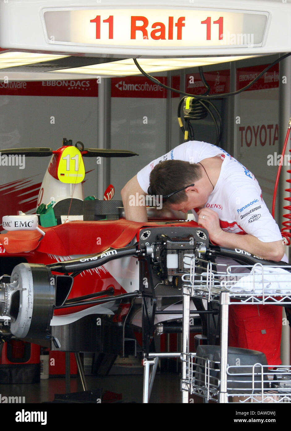 A mechanic of the Toyota F1 Team works on the racing car of German ...