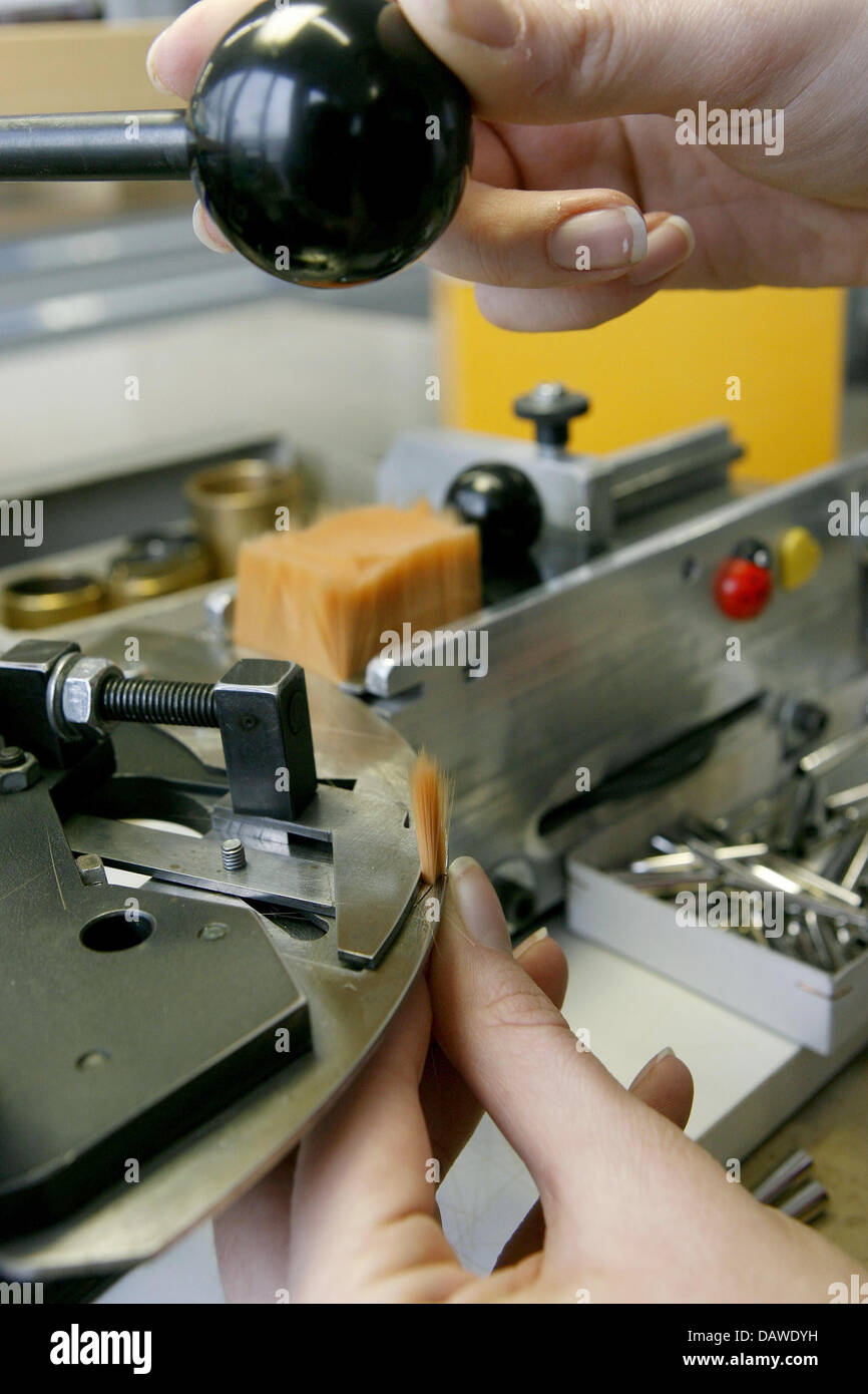 An employee assembles the parts of a brush at the artist's brush ...
