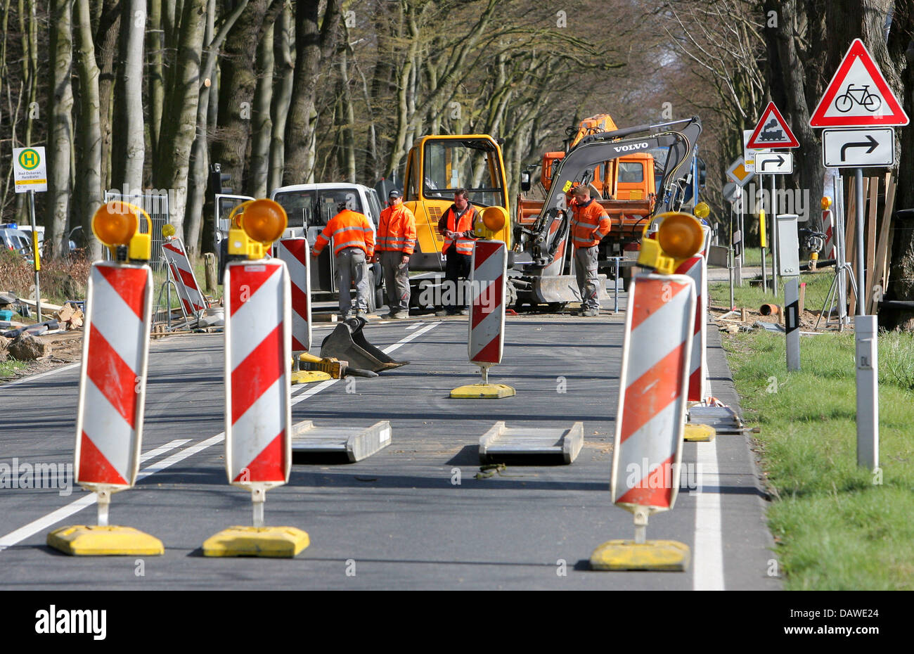 Construction workers prepare a road block at the security fence for the ...