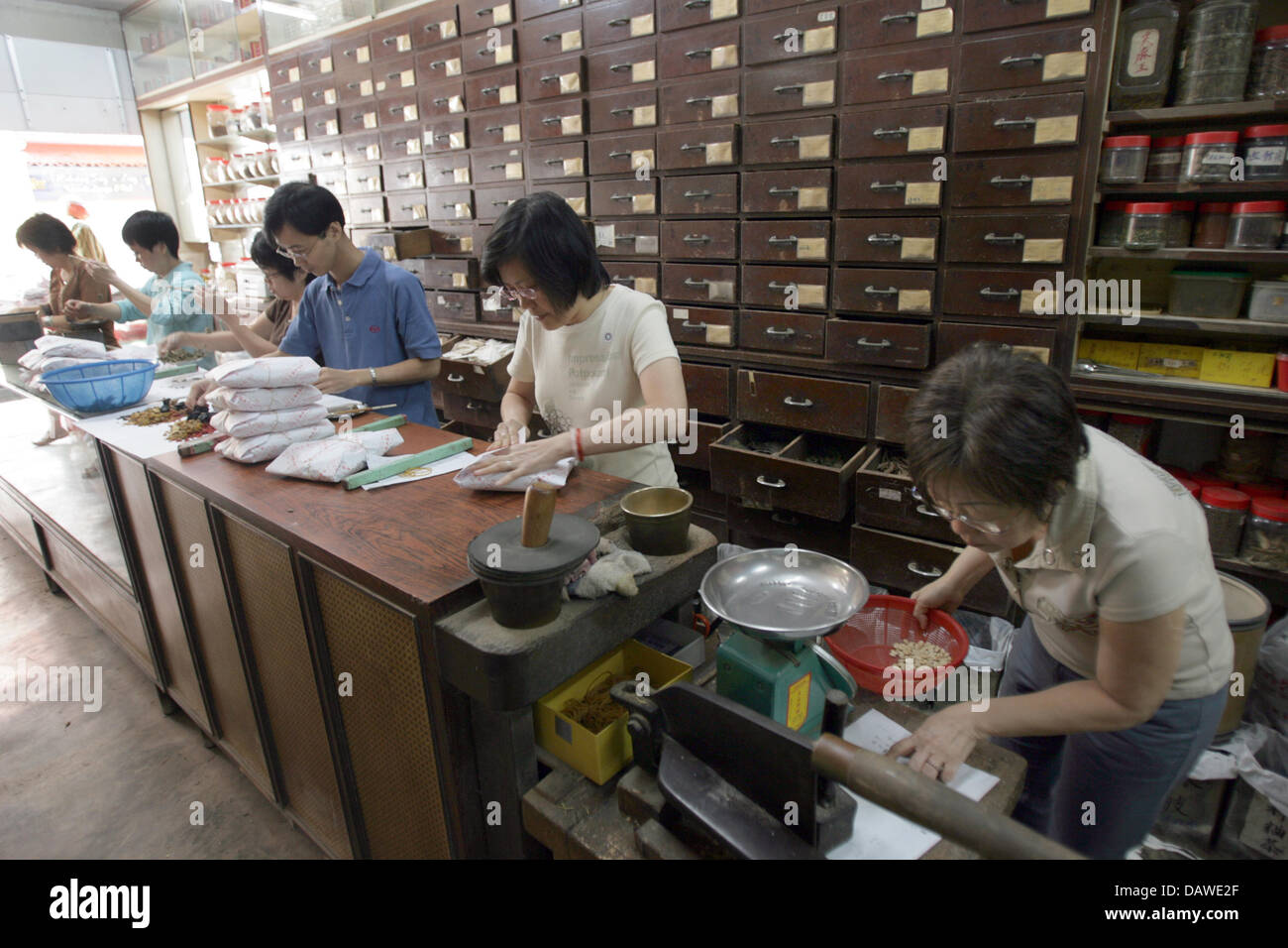 Staff of a pharmacy for Traditional Chinese medicine (TCM) arrange ...