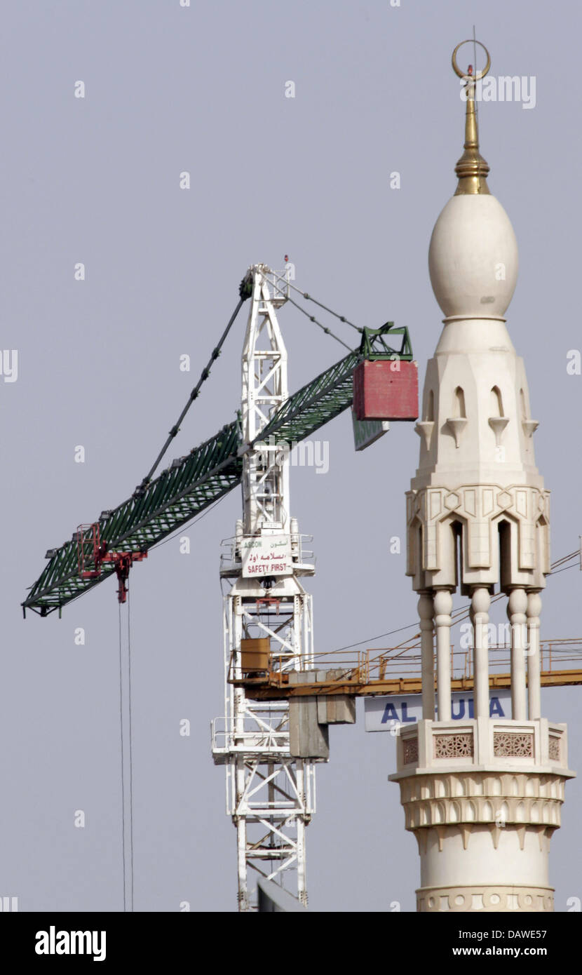 A crane shown in action behind a mosque's minaret at quarter Deira in ...
