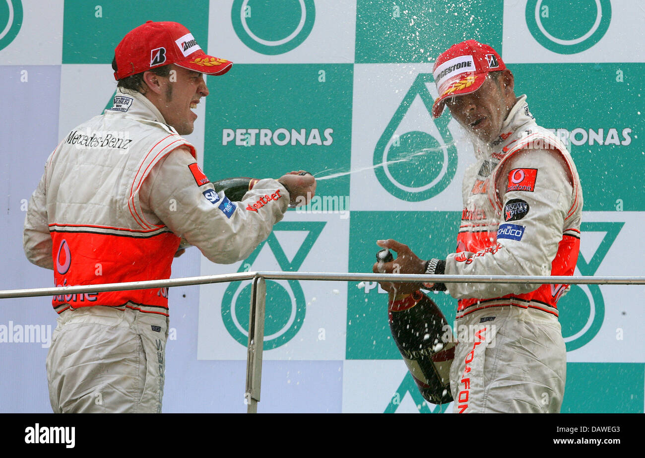 Spanish Formula 1 pilot Fernando Alonso (L) and his British teammate ...