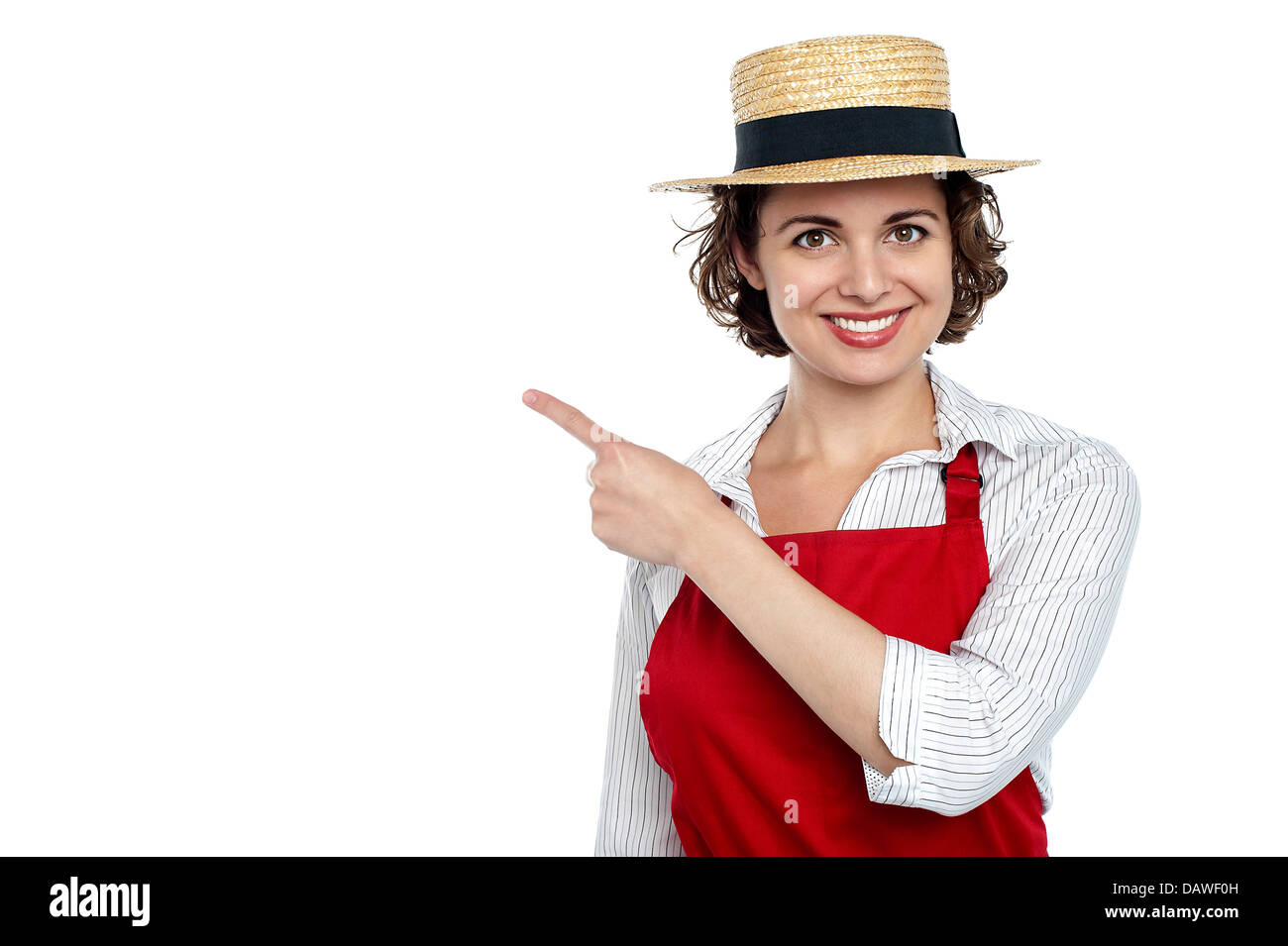 Cute woman in hat pointing sideways Stock Photo - Alamy