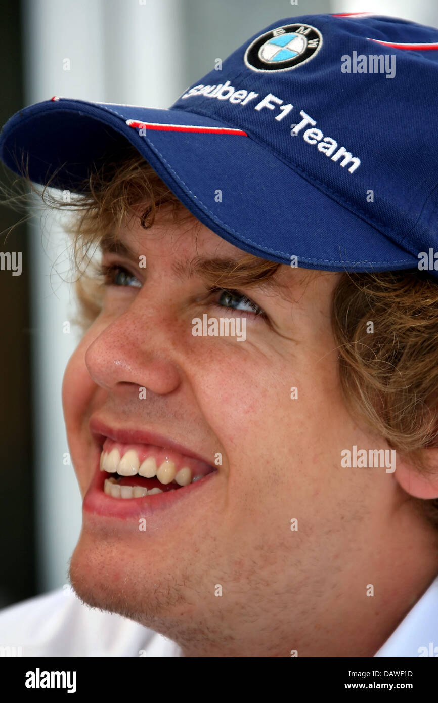 German Formual One test pilot Sebastian Vettel of BMW Sauber smiles at ...