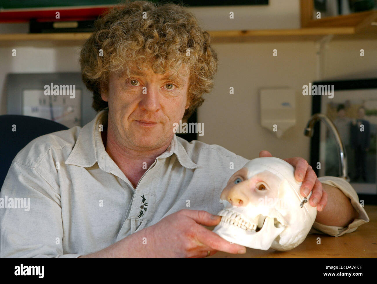 Anaplastologist Norbert Schilling holds an artificial skull with two ...
