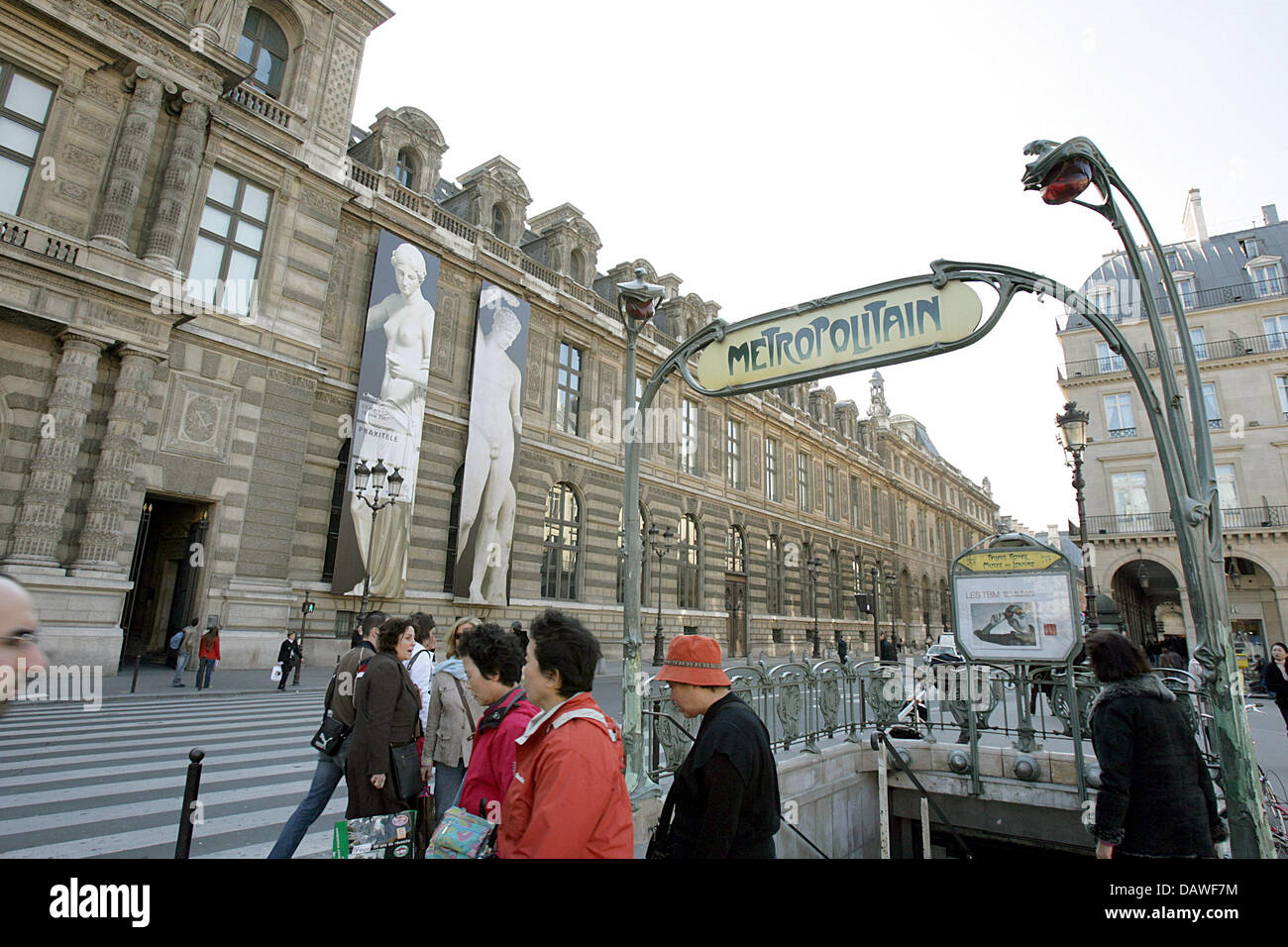 Passengers exit the Metro station at the Louvre museum in Paris, France ...