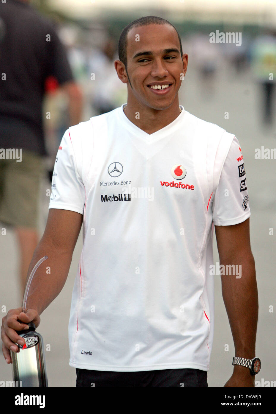 British Formula One rookie Lewis Hamilton walks smiling through the ...
