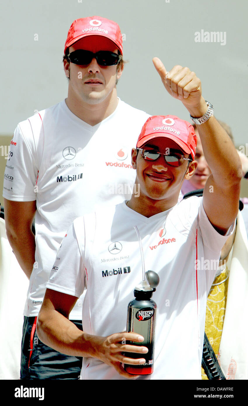 Spanish Formula One driver Fernando Alonso (rear) and British Lewis ...