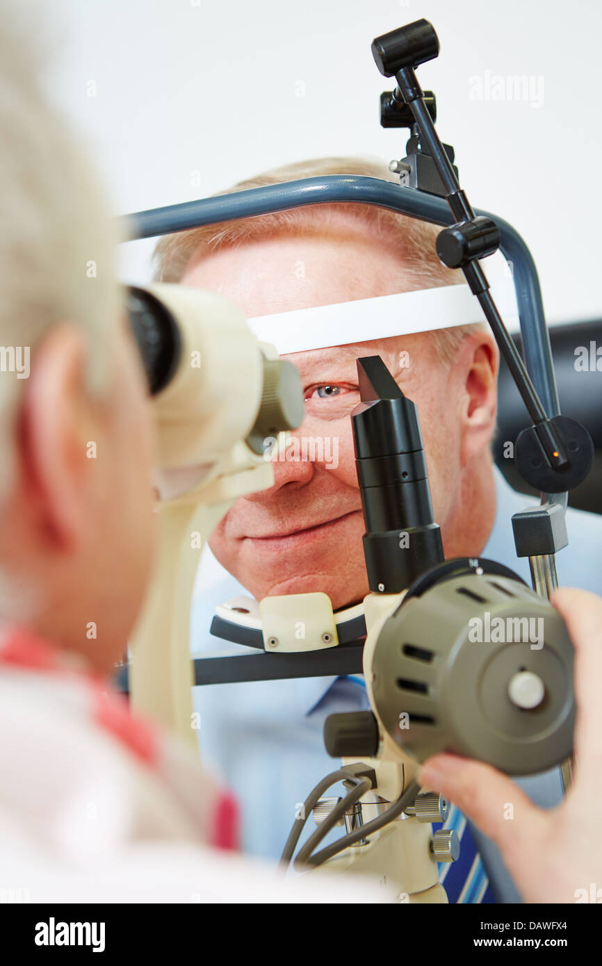 Oculist measuring cornea of elderly man with slit lamp Stock Photo - Alamy