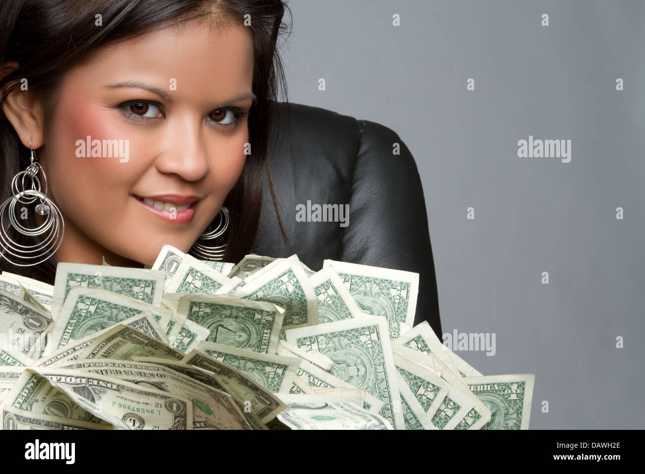 Woman sitting pile of money hi-res stock photography and images - Alamy