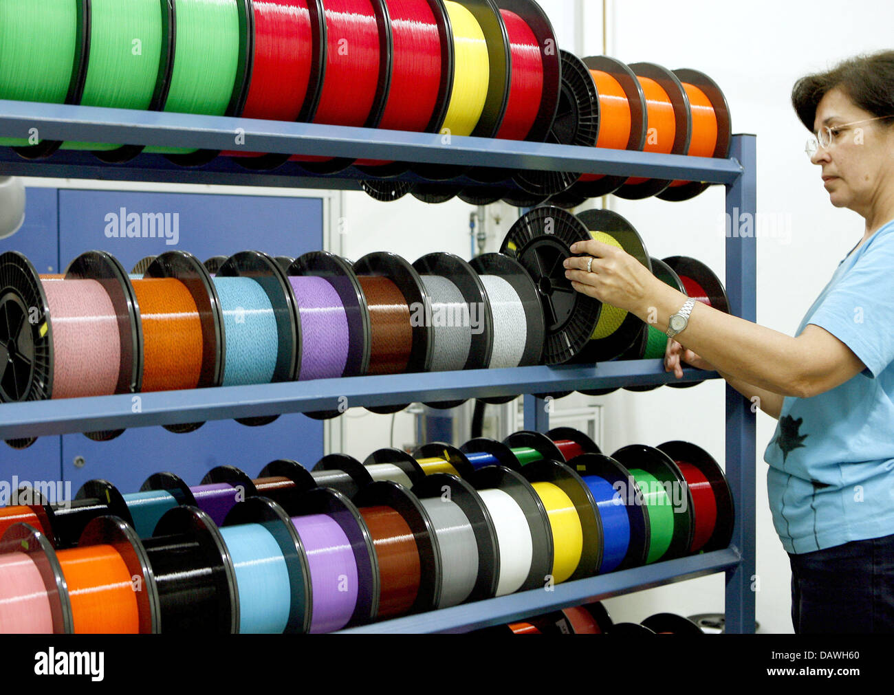 A worker of the cable and electrical systems manufacturer Leoni puts a ...