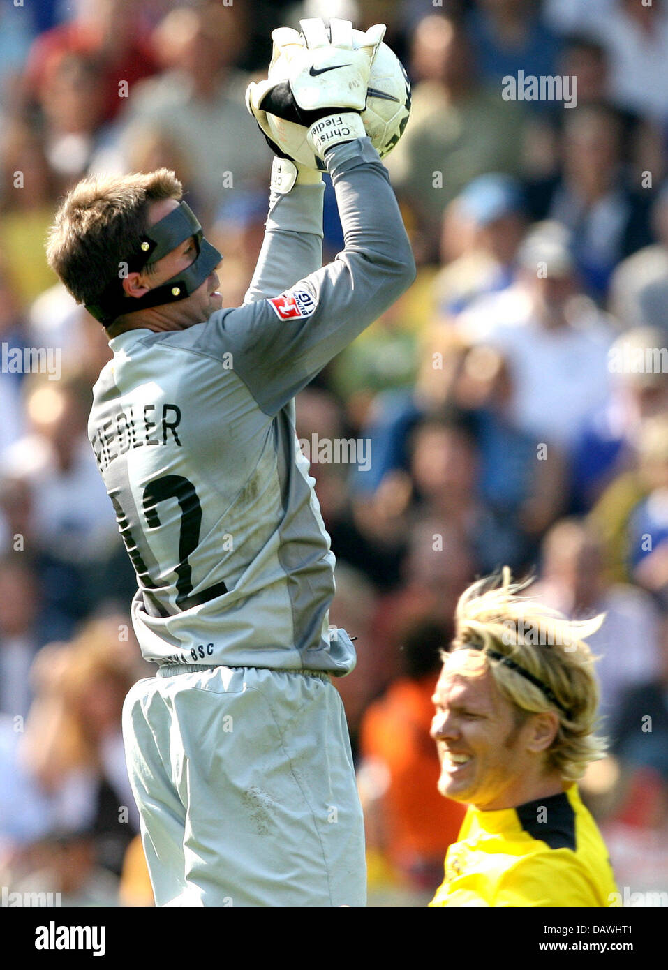 Berlin's goalie Christian Fiedler (L) catches a ball before Aachen's ...