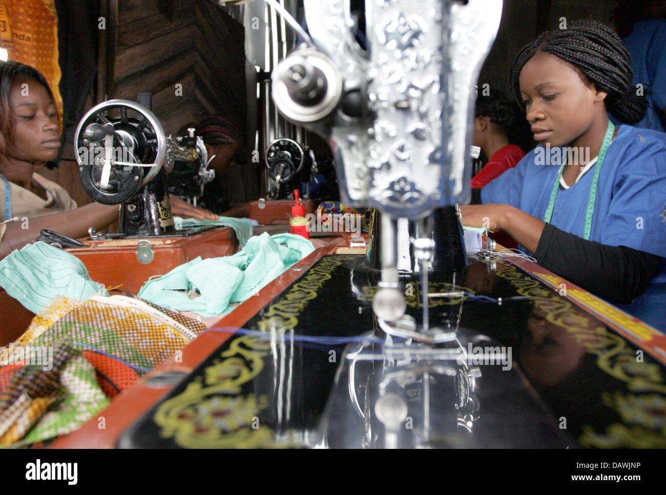 Young Congolese women work on sewing machines in a slum of Kinshasa, DR ...