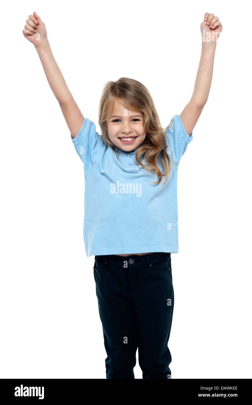 Cute caucasian girl celebrating with raised arms Stock Photo - Alamy