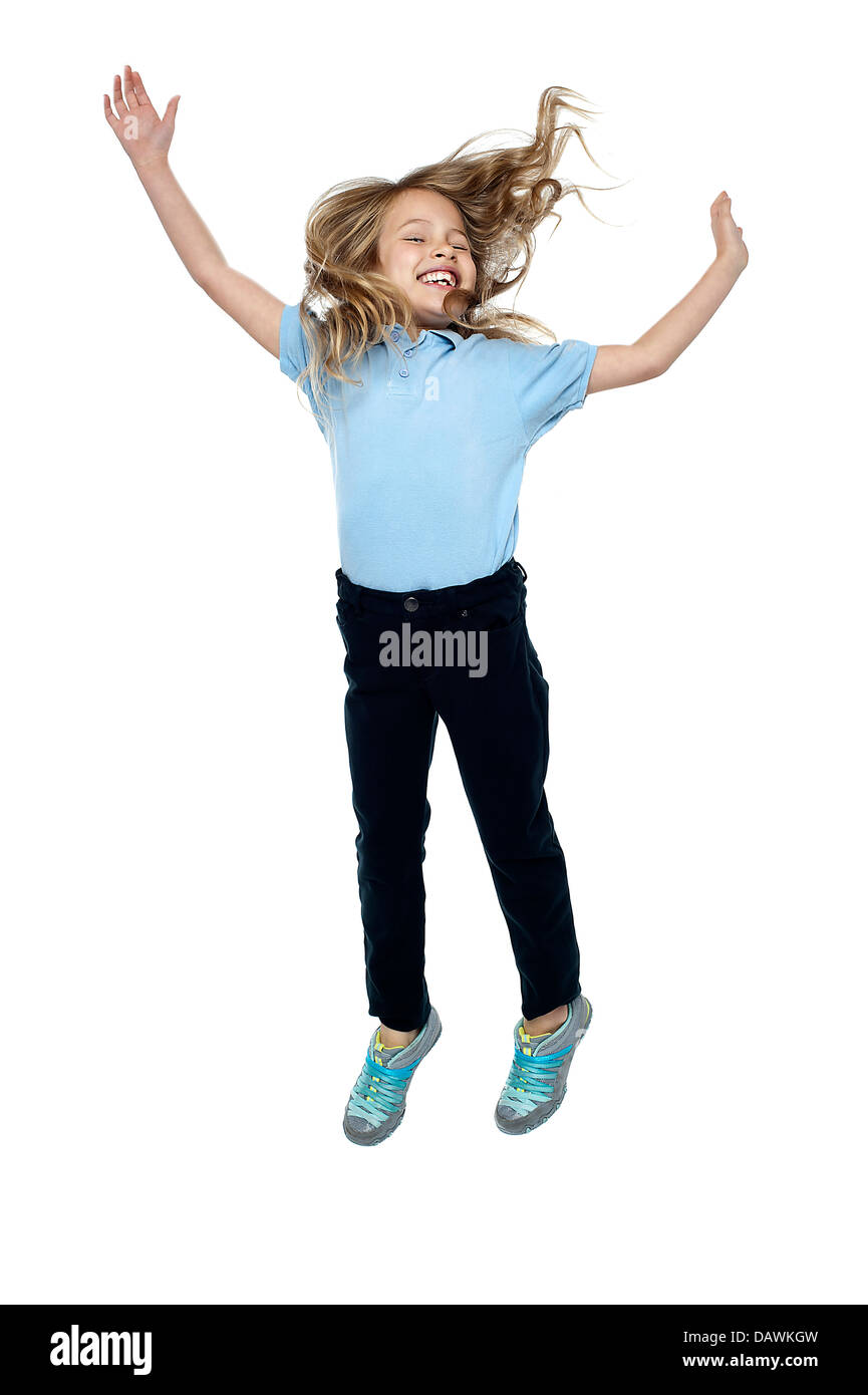 Delighted young girl jumping high in the air Stock Photo - Alamy