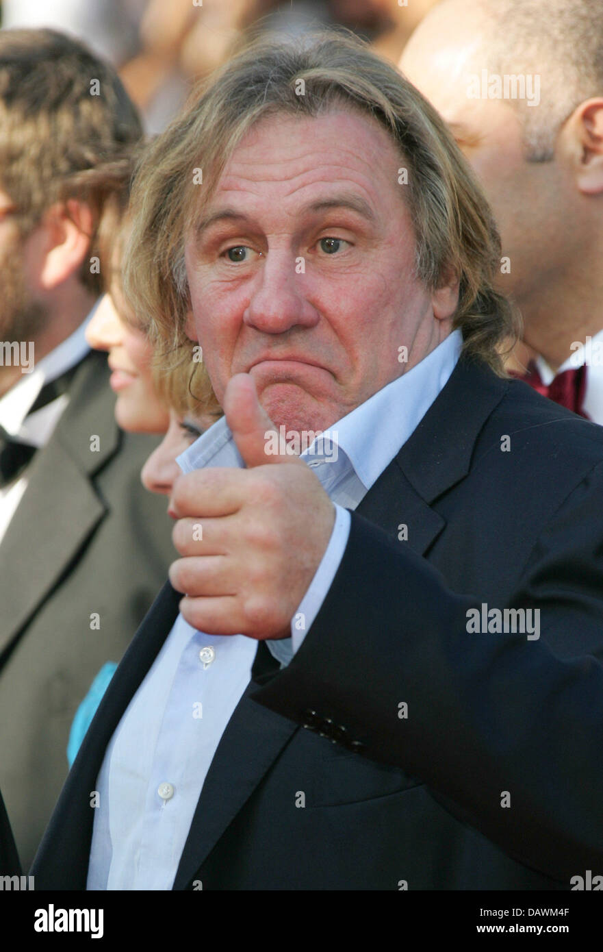 French actor Gerard Depardieu thumbs up to the cameras as he arrives at ...