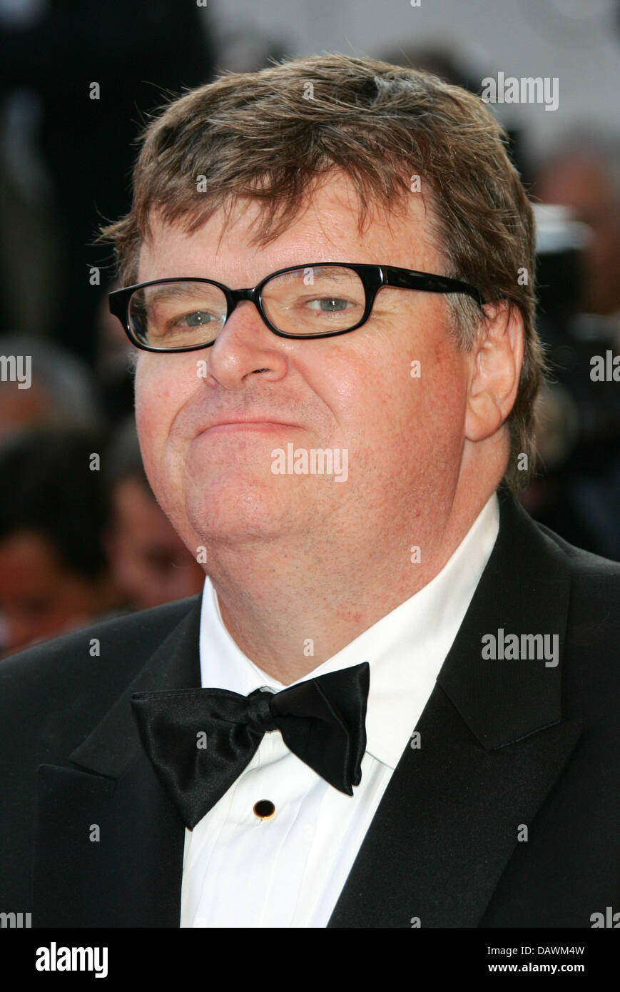 US filmmaker Michael Moore smiles for the cameras as he arrives at the ...
