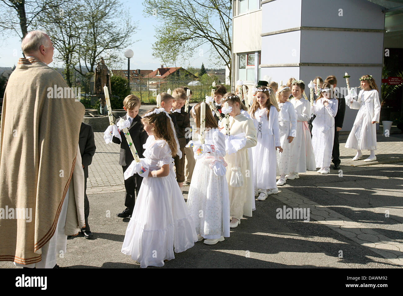 Children line up to enter the church for their First Communion in ...