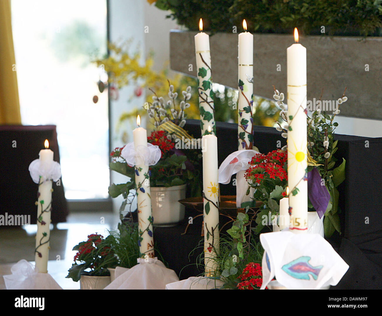 Candles stand lit on the altar during a First Communion in Baierbrunn ...
