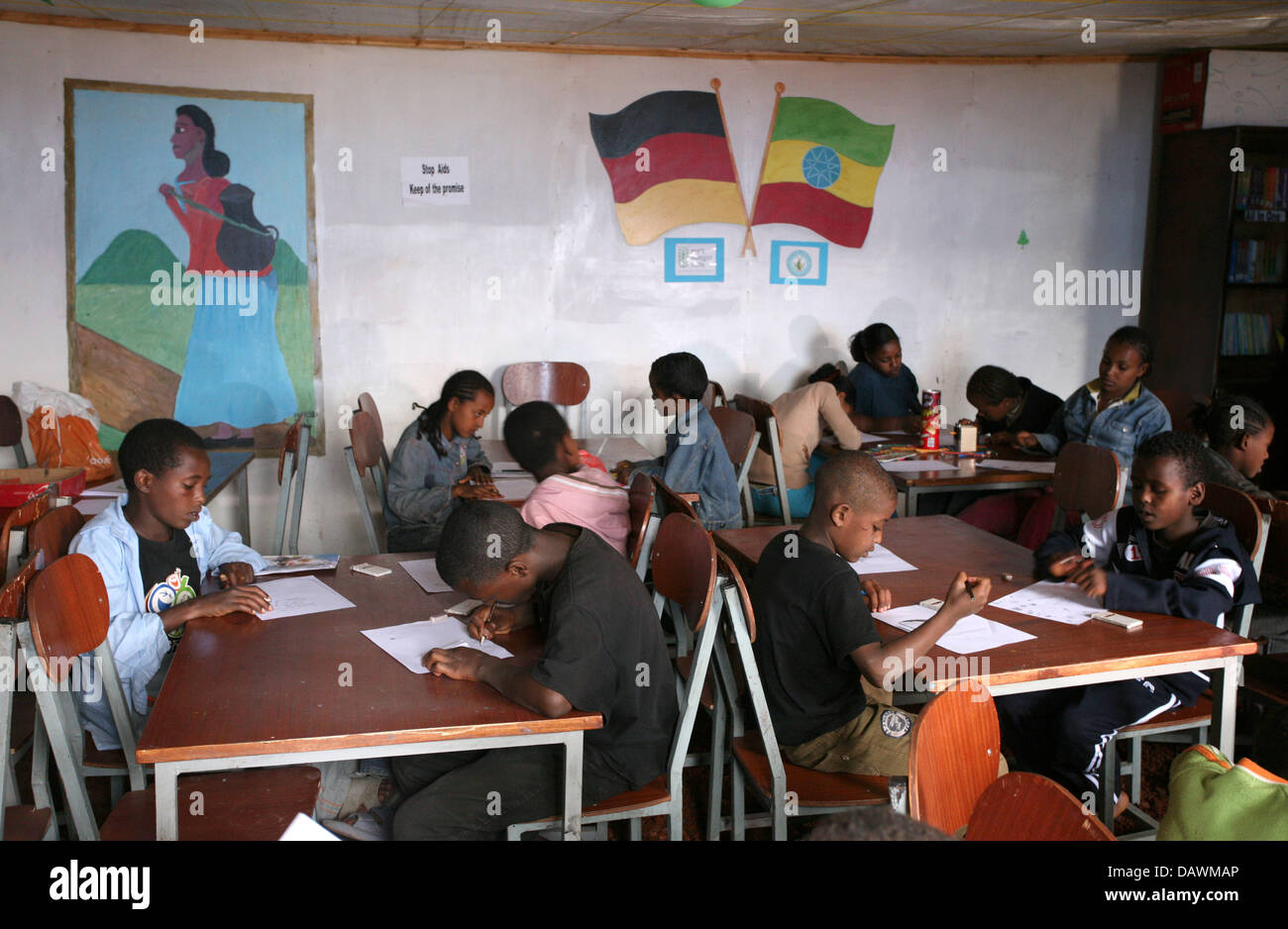 Ethiopian orphans paint pictures in a classroom at an aide project of ...