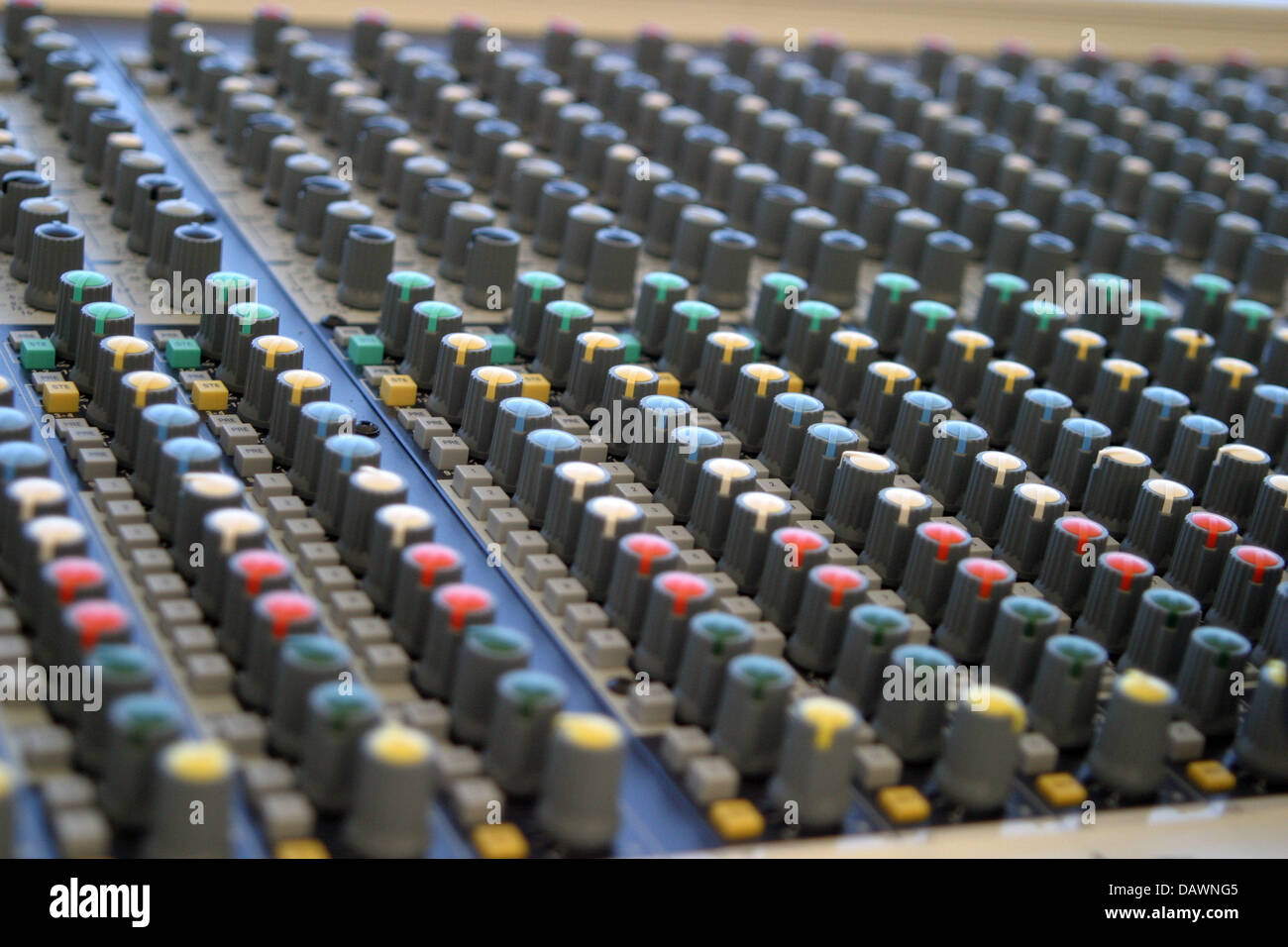 The picture shows a mixing console with various colourful buttons ...