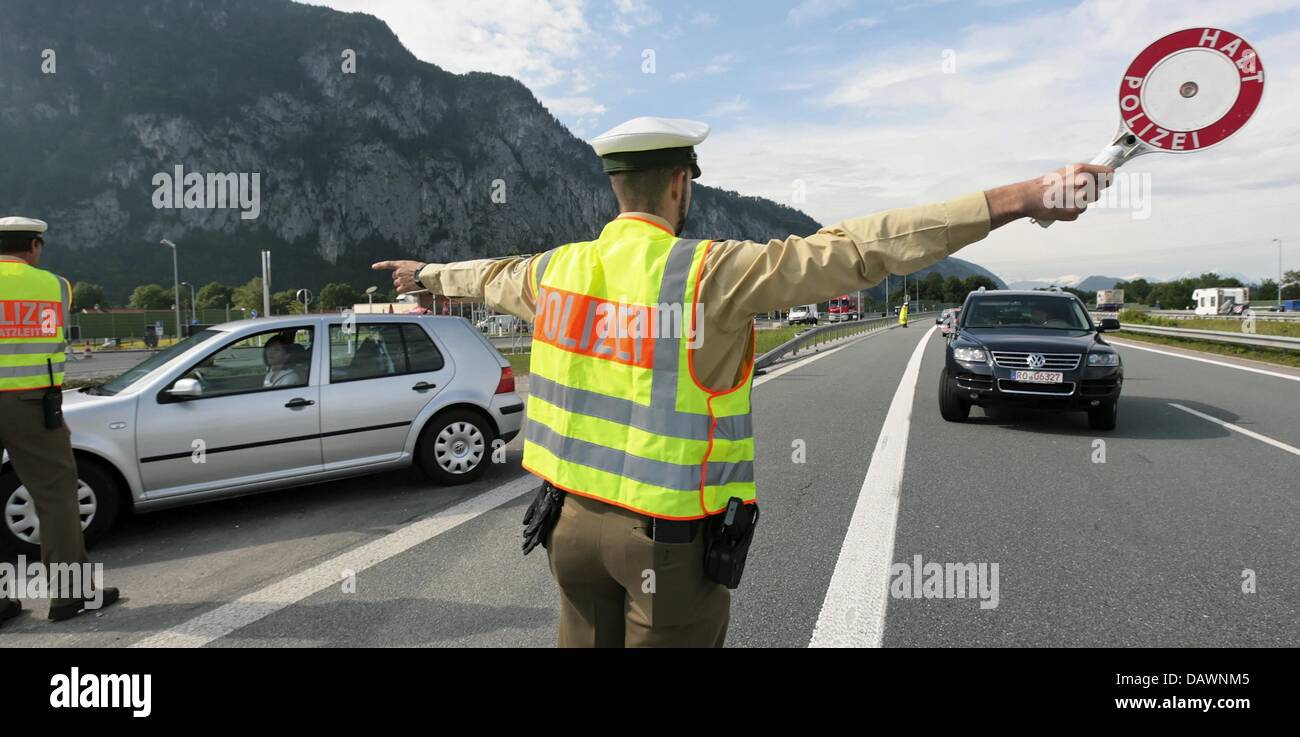 A policeman waves aside cars at the German-Austrian border crossing in ...