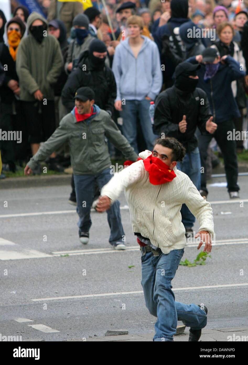 Protesters throw stones at the riot police during a protest march ...