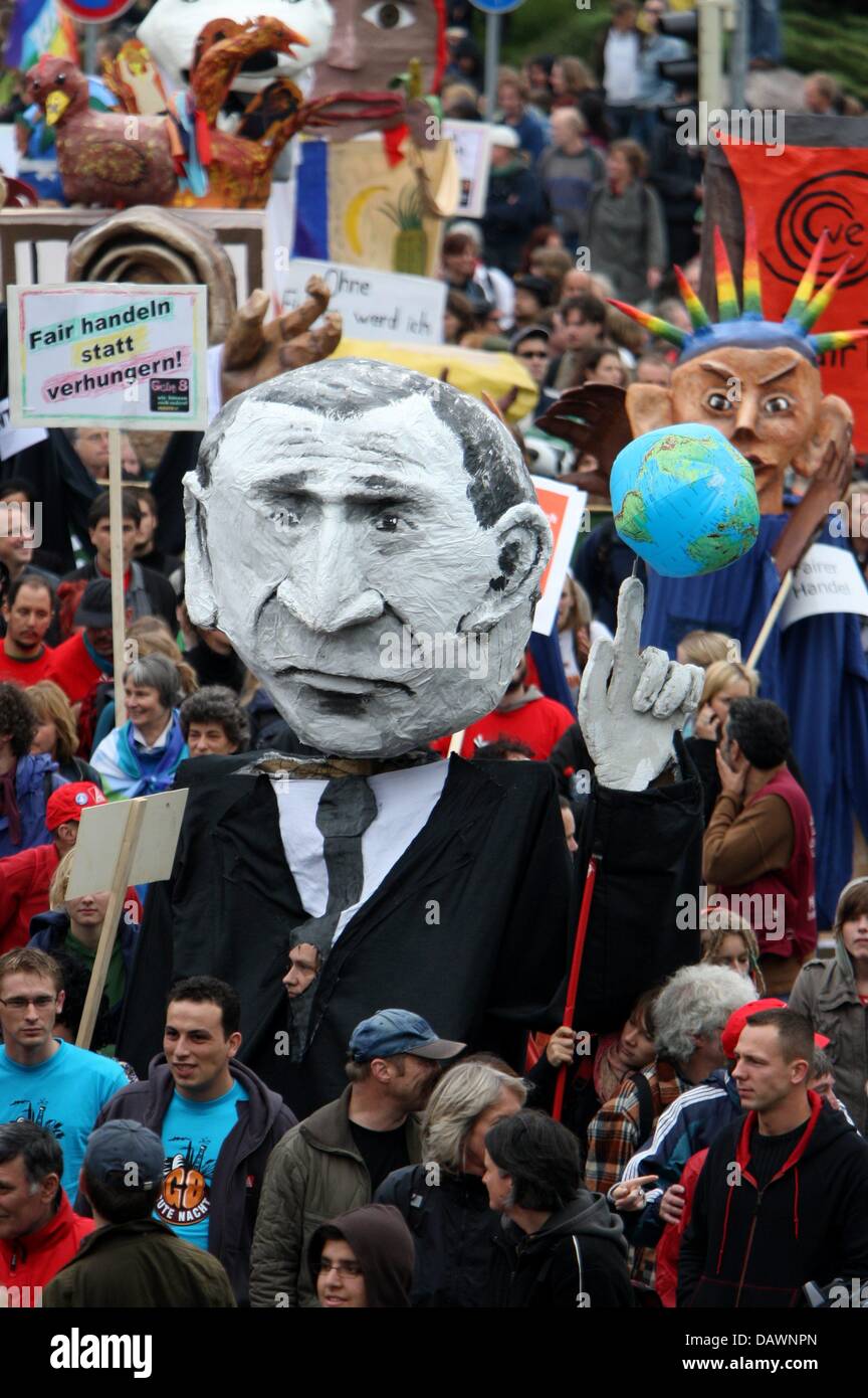 Anti-globalisation critics carry banners and and papier-maché effigies ...